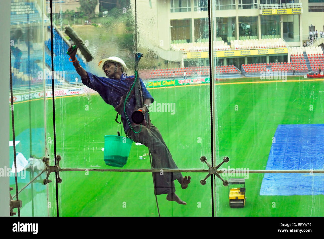 Glass cleaner at D Y Patil cricket stadium ; Nerul ; Navi Bombay Mumbai ...