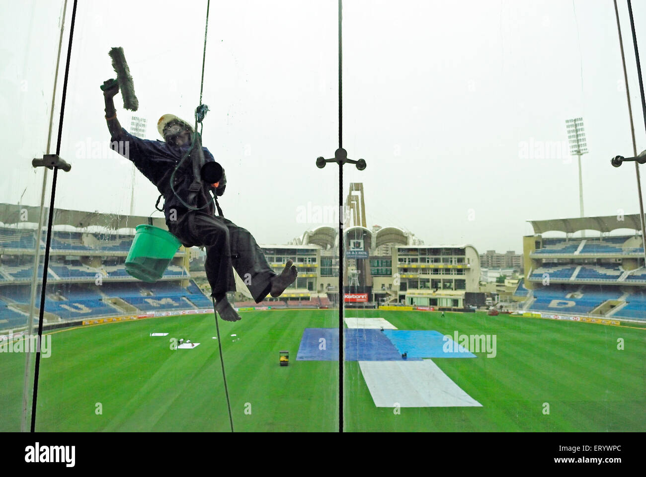 Glass cleaner at D Y Patil cricket stadium ; Nerul ; Navi Bombay Mumbai ...