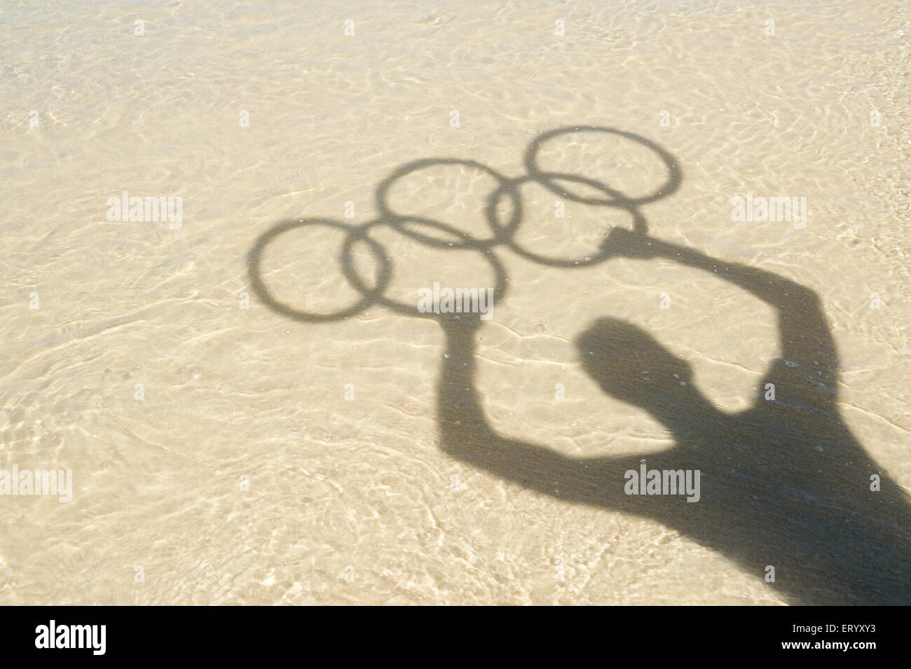 RIO DE JANEIRO, BRAZIL - MARCH 20, 2015: Shadow of man holding Olympic ...