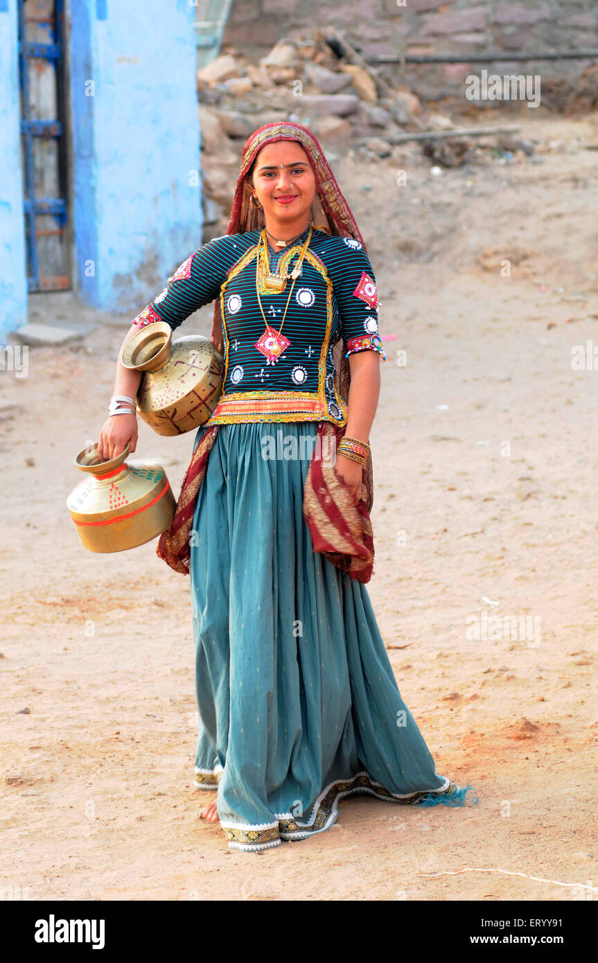 Rabari girl carrying vessel ; Bhuj ; Kutch ; Gujarat ; India MR#771E ...