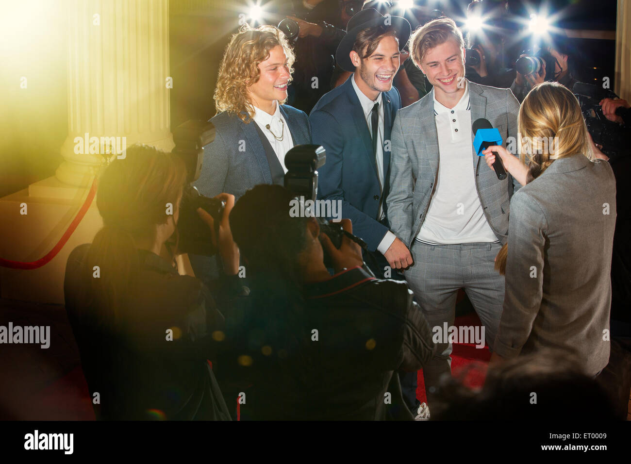 Smiling celebrities being interviewed at event Stock Photo - Alamy