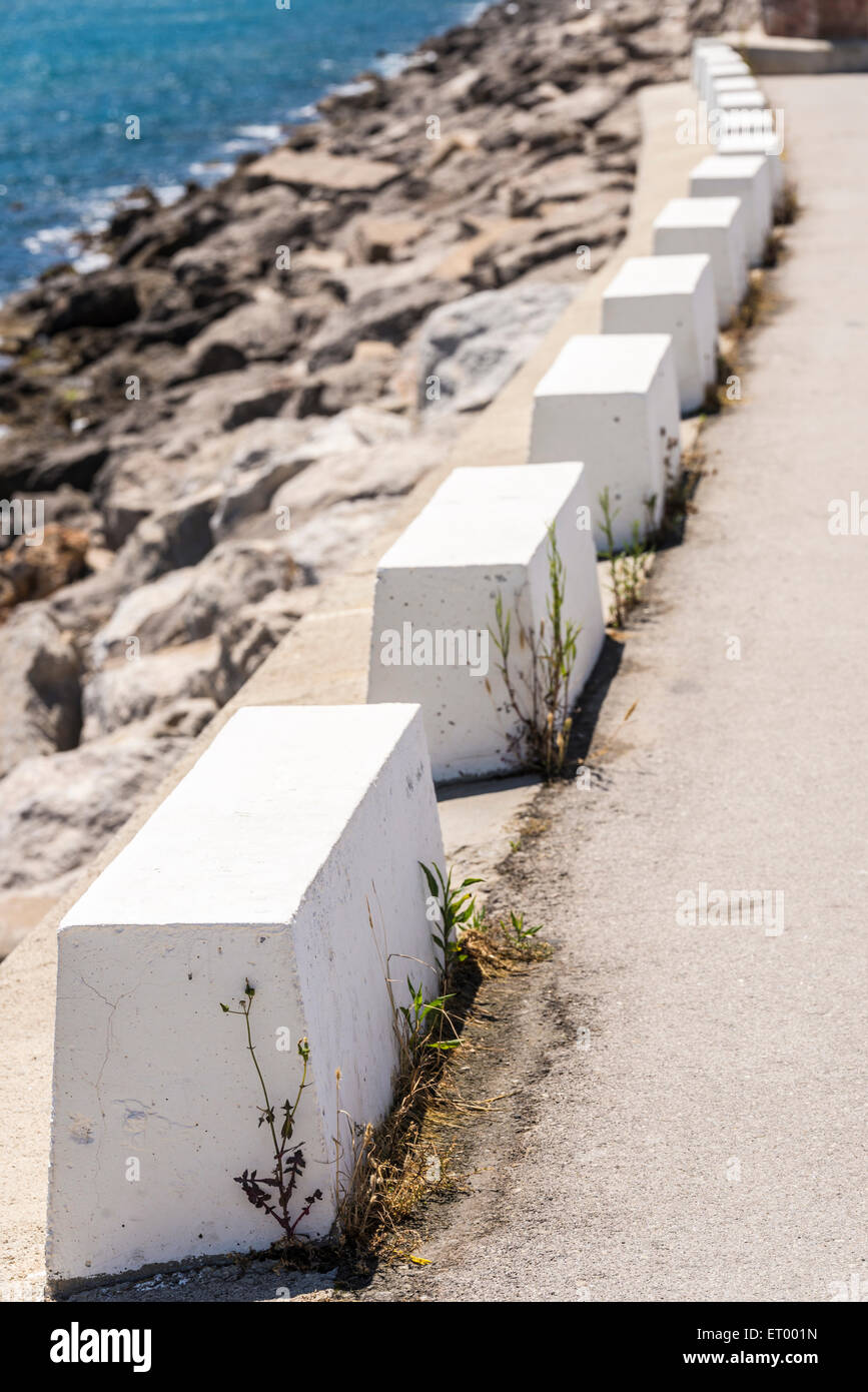 Row of white stone pylons on the seafront of Barcelona Stock Photo - Alamy