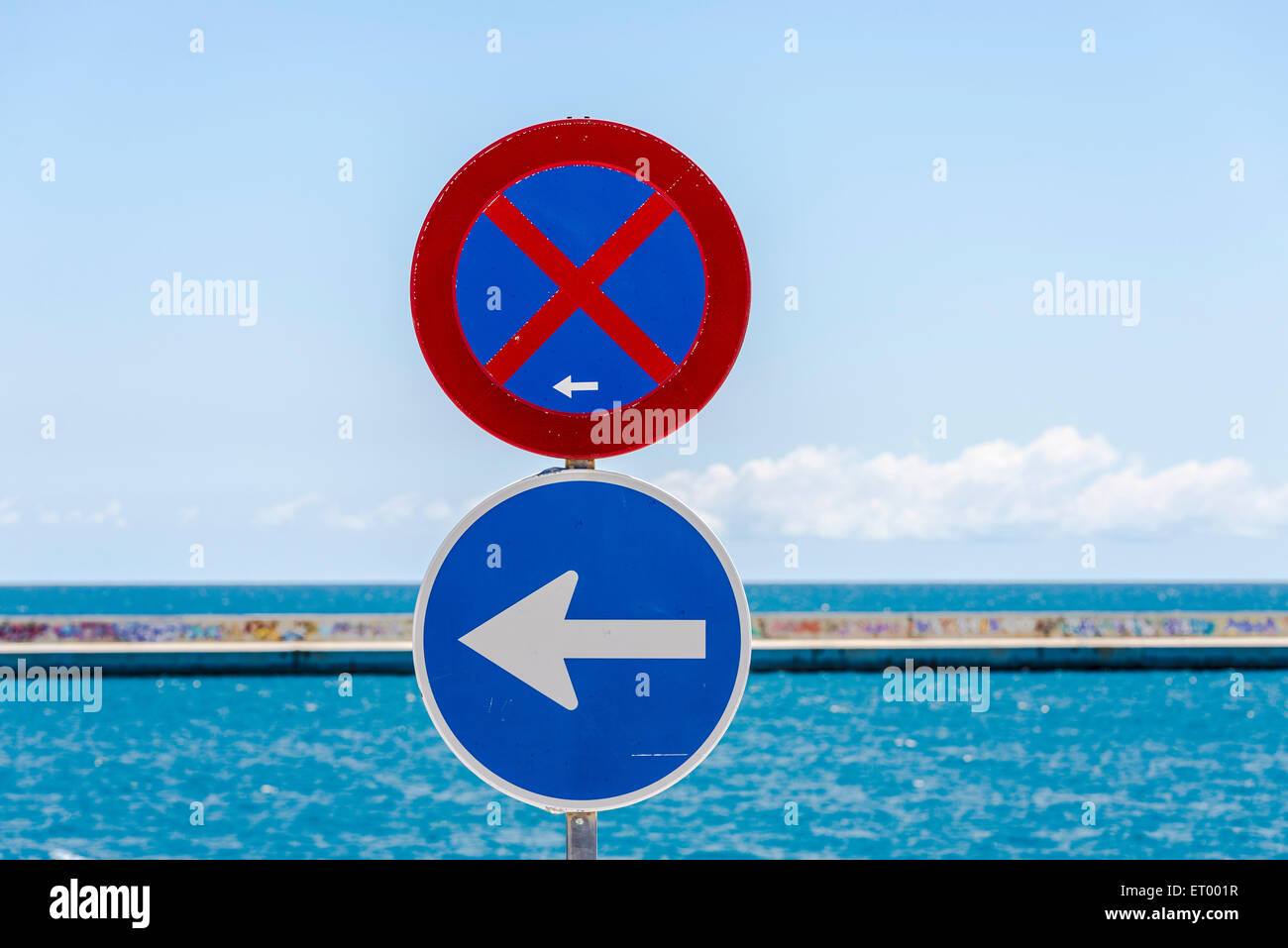 No parking sign and another sign of compulsory direction with the sea ...