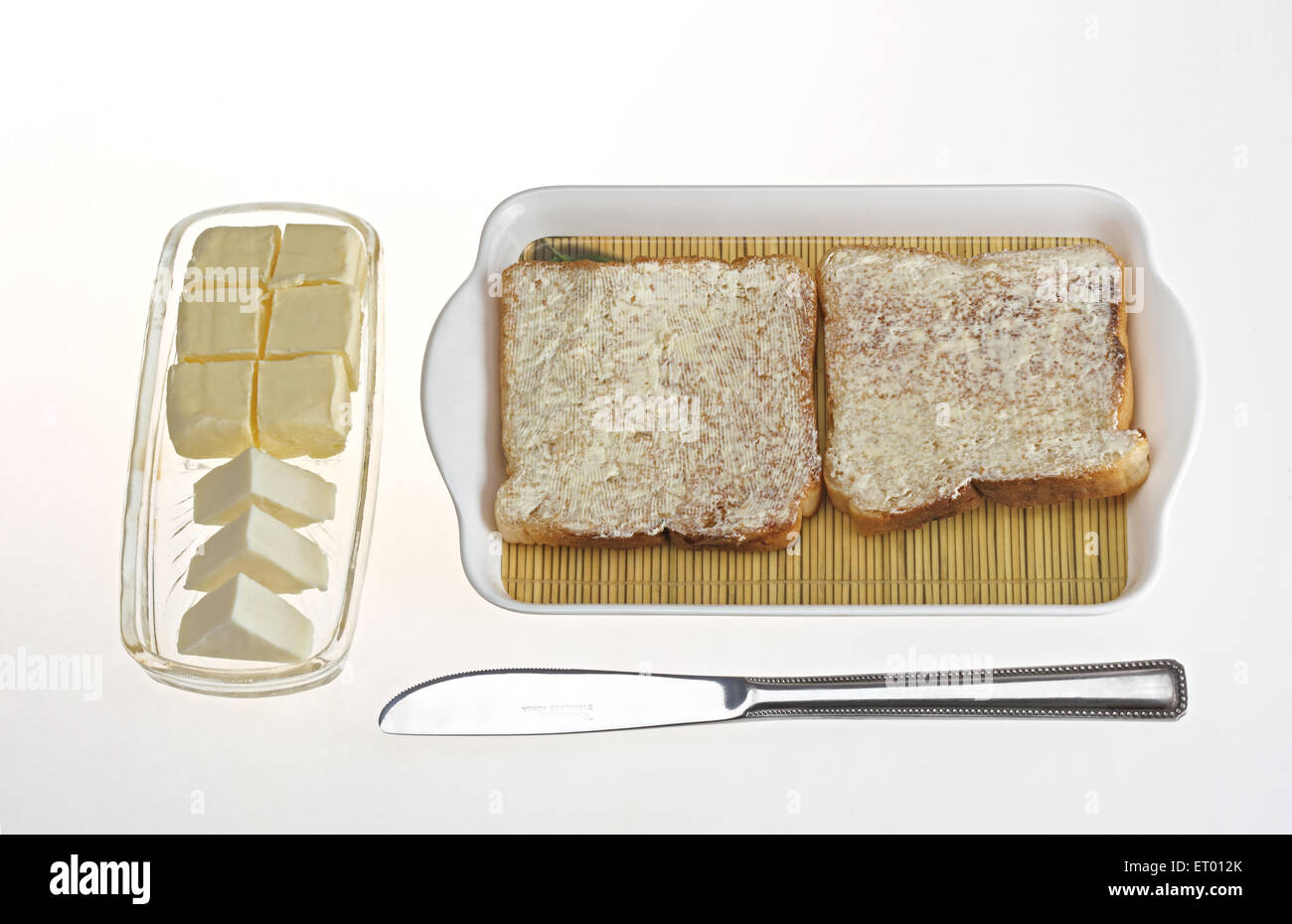 Bread toast with butter spread and pieces of cheese cubes and butter ...