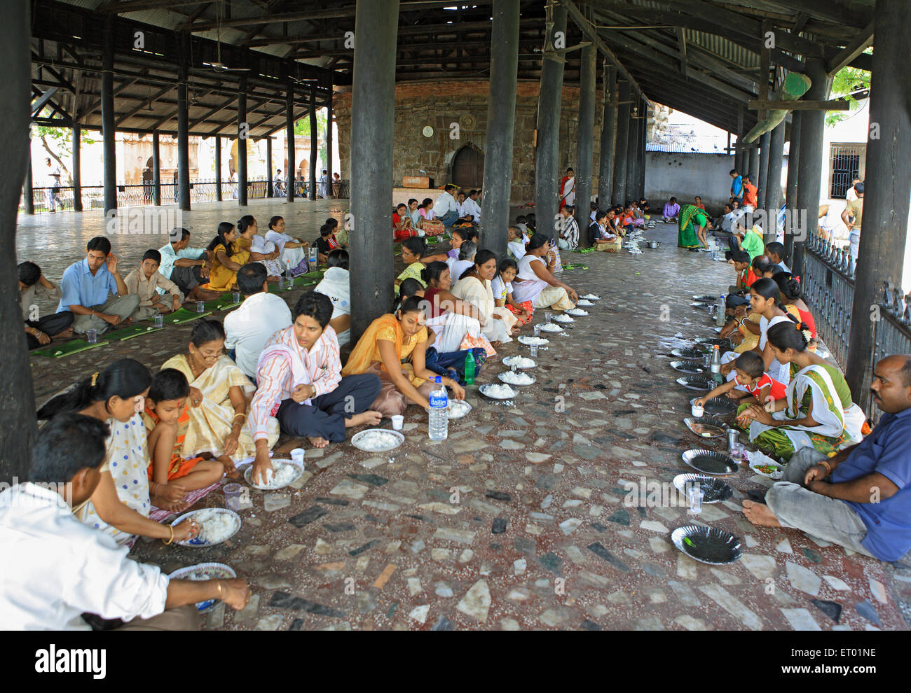 Pilgrims eating food in hayagribha maghadeva mahadap temple ; Guwahati ...