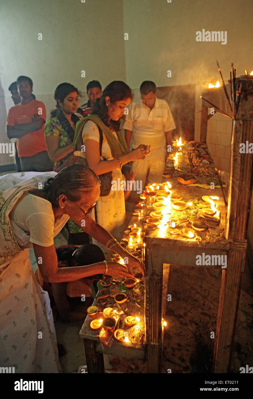 Devotees lighting diyas at mahabhairav shiva temple ; Assam ; India ...