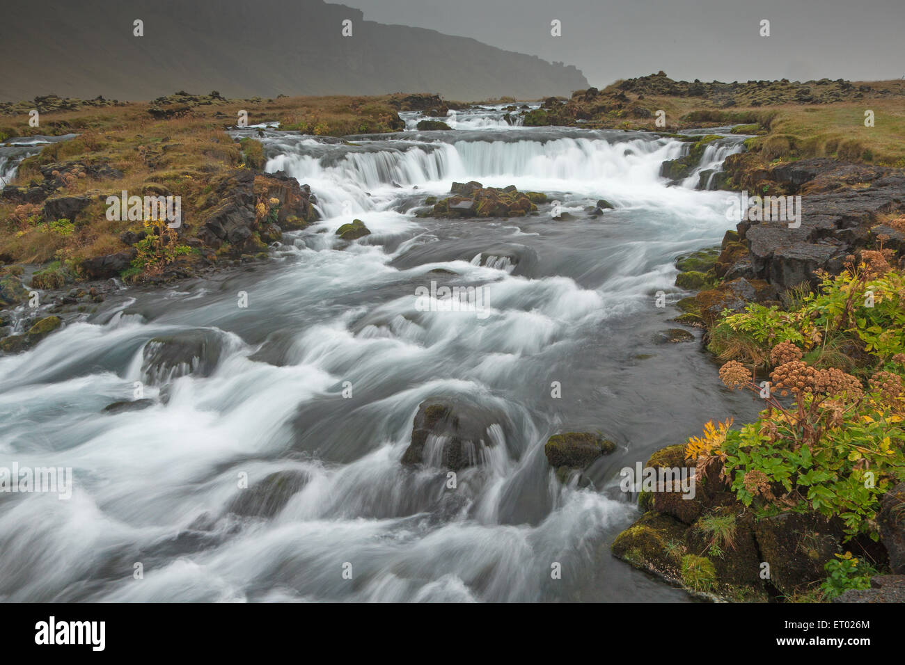 Waterfall through remote landscape, Vik, Iceland Stock Photo - Alamy