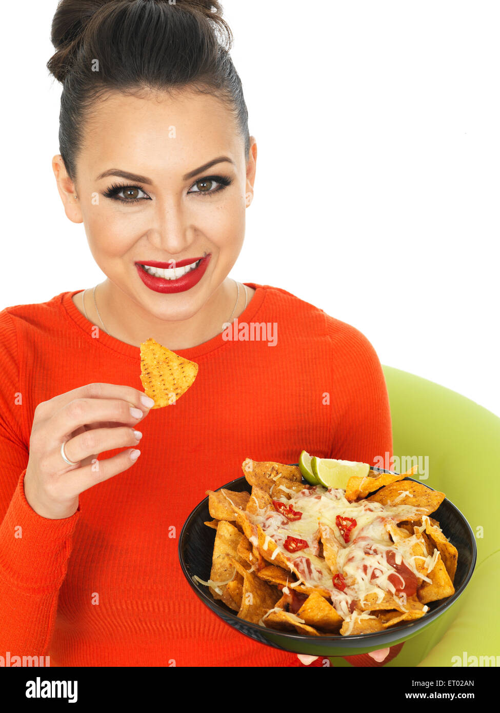 Young Hispanic Woman With A Dish Of Mexican Style Nachos Covered In ...