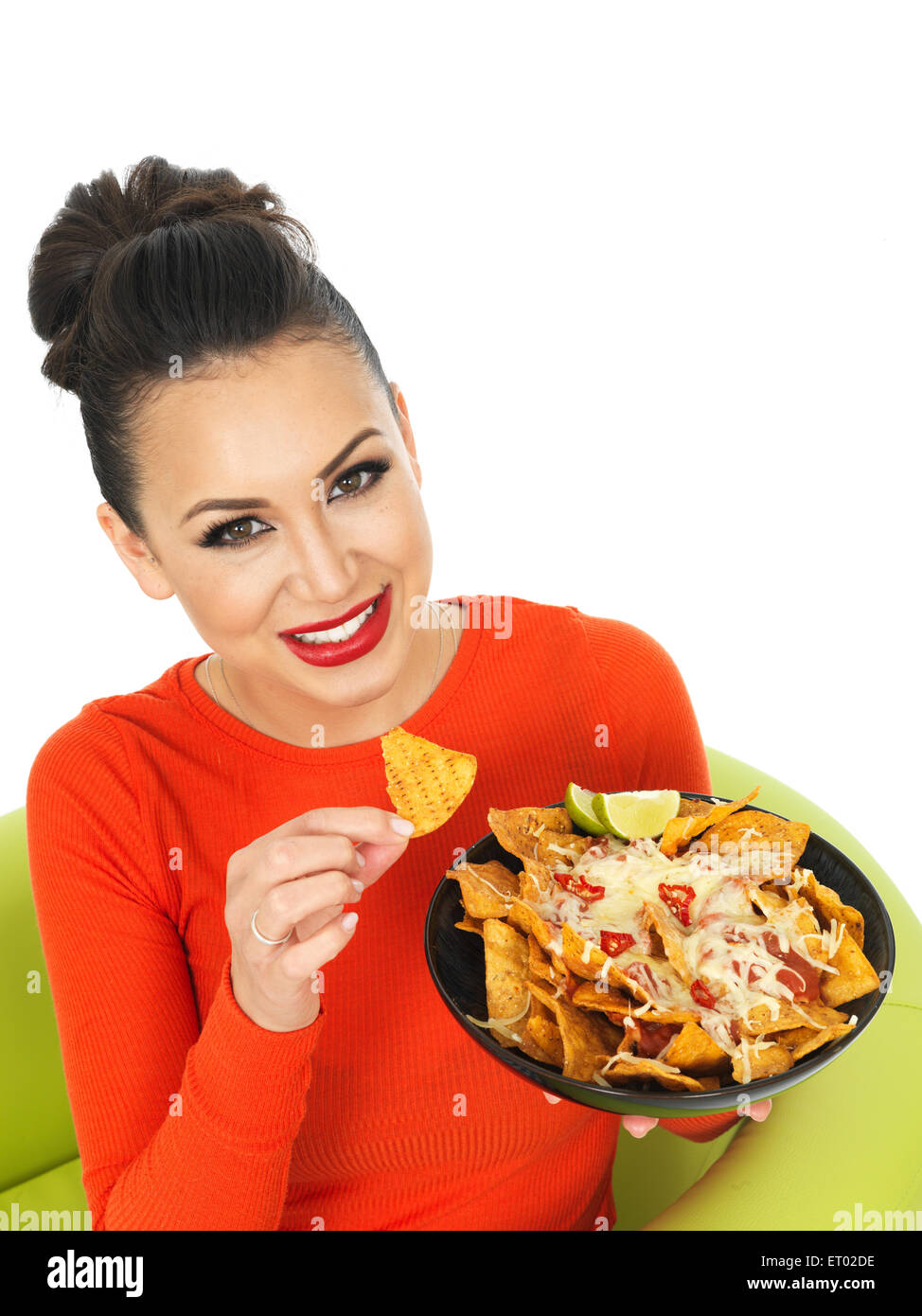 Young Hispanic Woman With A Dish Of Mexican Style Nachos Covered In ...