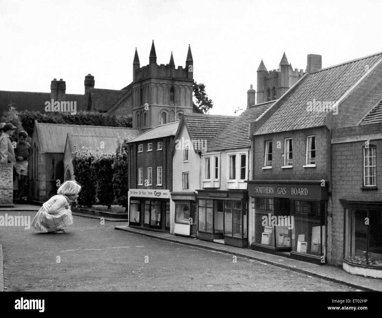 A child looking at the shops at Wimborne Minster Model Town & Gardens ...