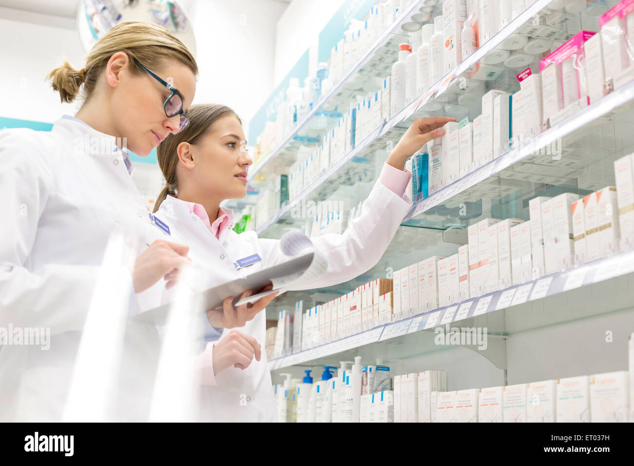 Pharmacists taking inventory in pharmacy Stock Photo - Alamy