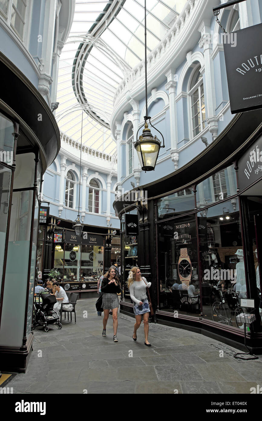 Young women looking in shop windows shopping in Morgan Arcade Cardiff ...