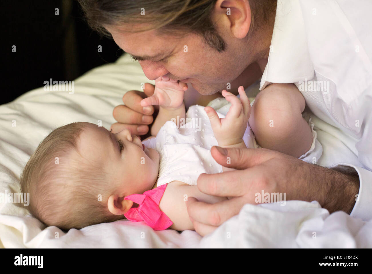 father smiling at his baby daughter Stock Photo - Alamy