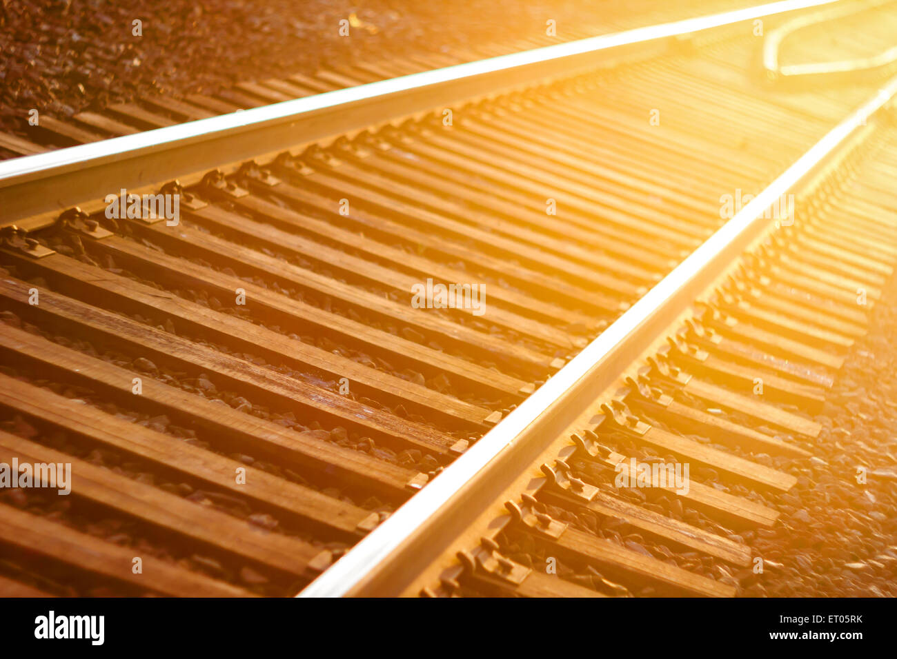 De focused curved railroad tracks in sunset with a lens flare Stock ...