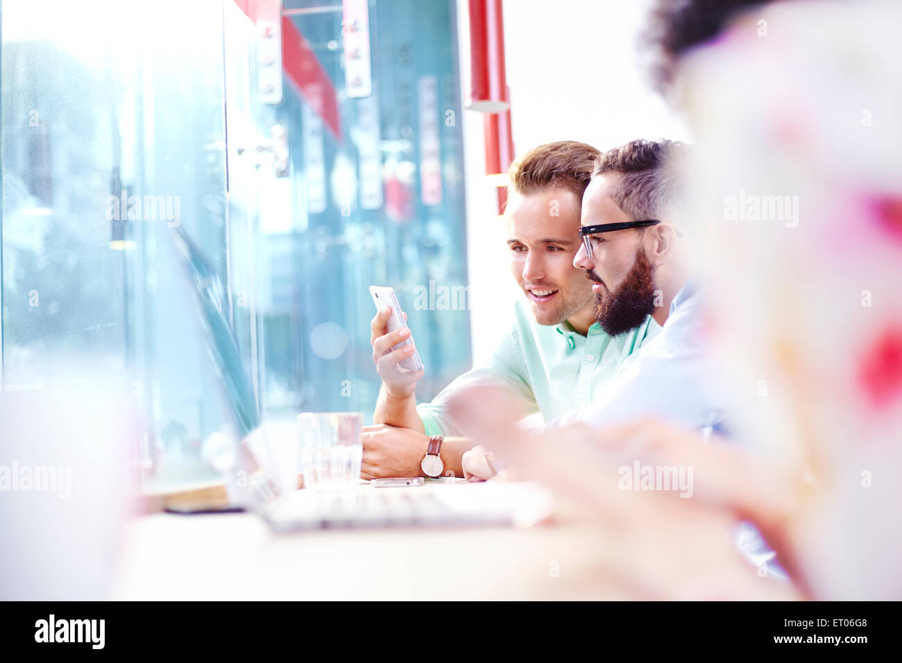 Businessmen texting with cell phone in cafe Stock Photo - Alamy