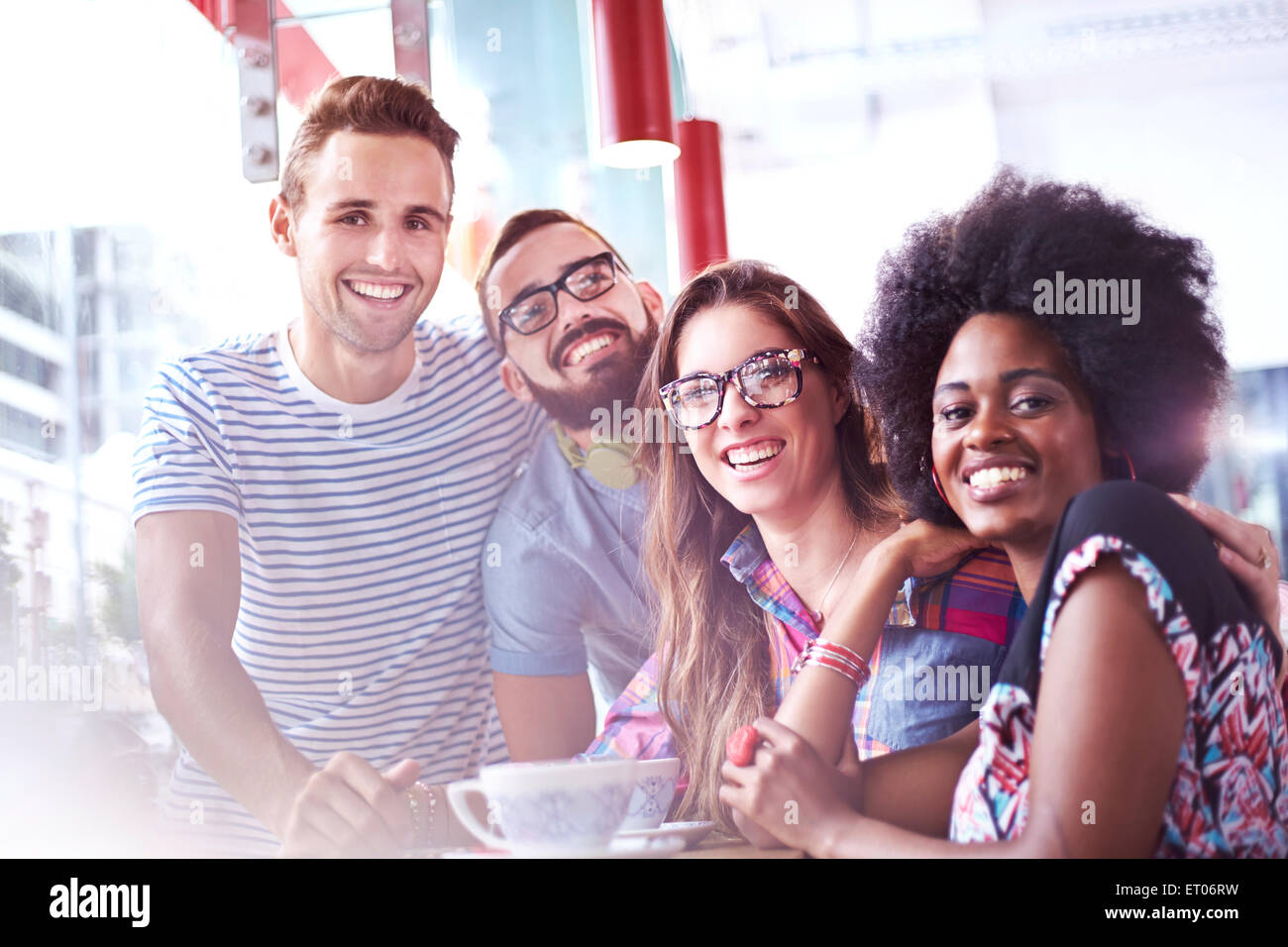 Portrait of smiling friends in cafe Stock Photo - Alamy
