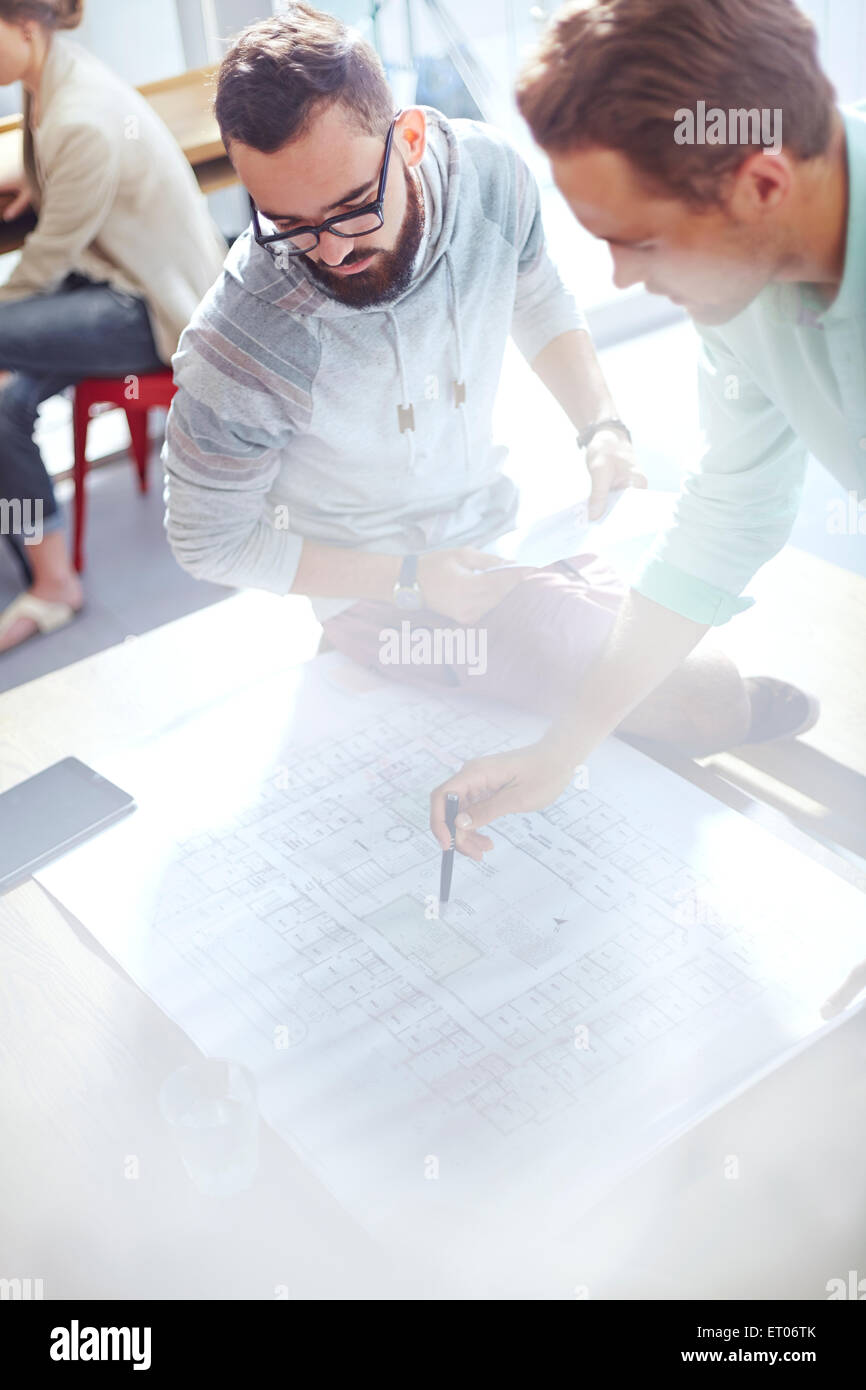 Architects reviewing blueprints Stock Photo - Alamy