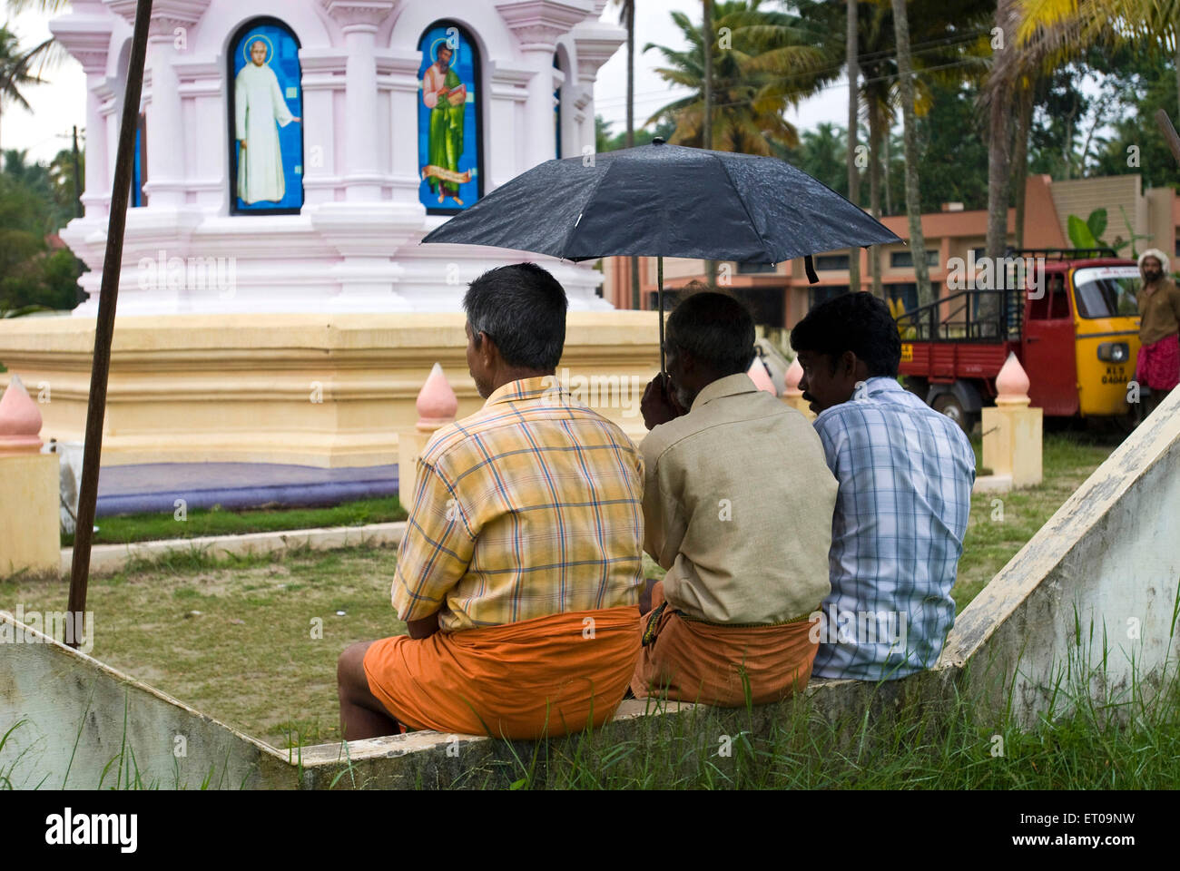 Keralites sitting near Vechoor church during a monsoon day ; Kerala ...