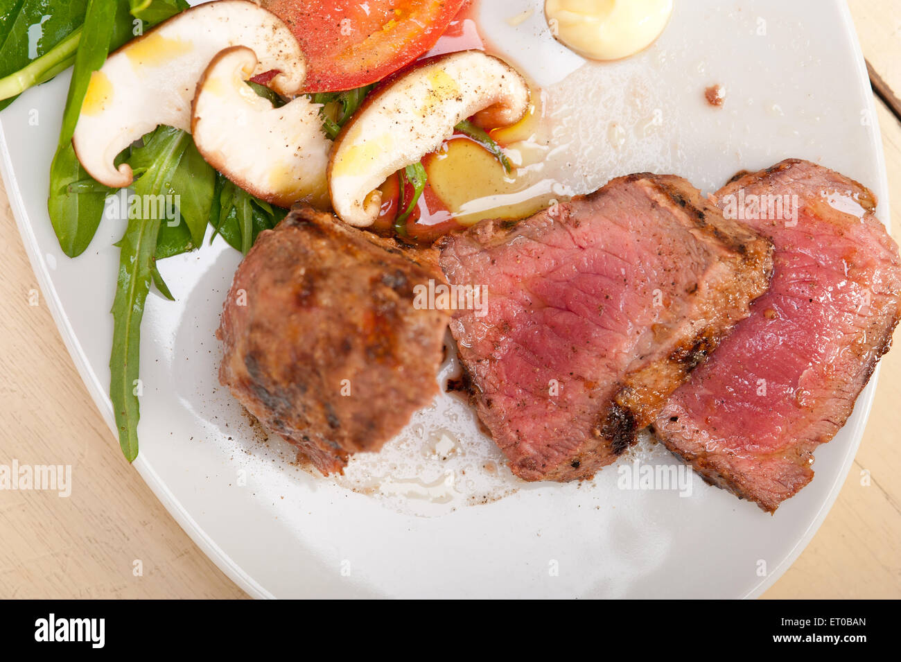 beef filet mignon grilled with fresh vegetables on side ,mushrooms tomato and arugula salad ...
