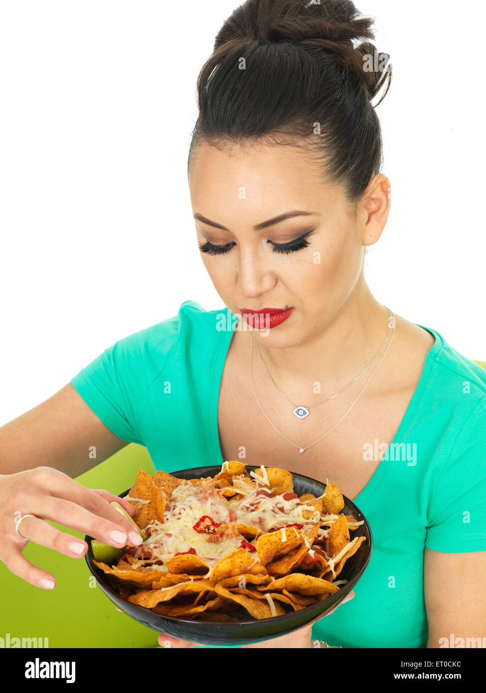 Young Hispanic Woman With A Dish Of Mexican Style Nachos Covered In ...
