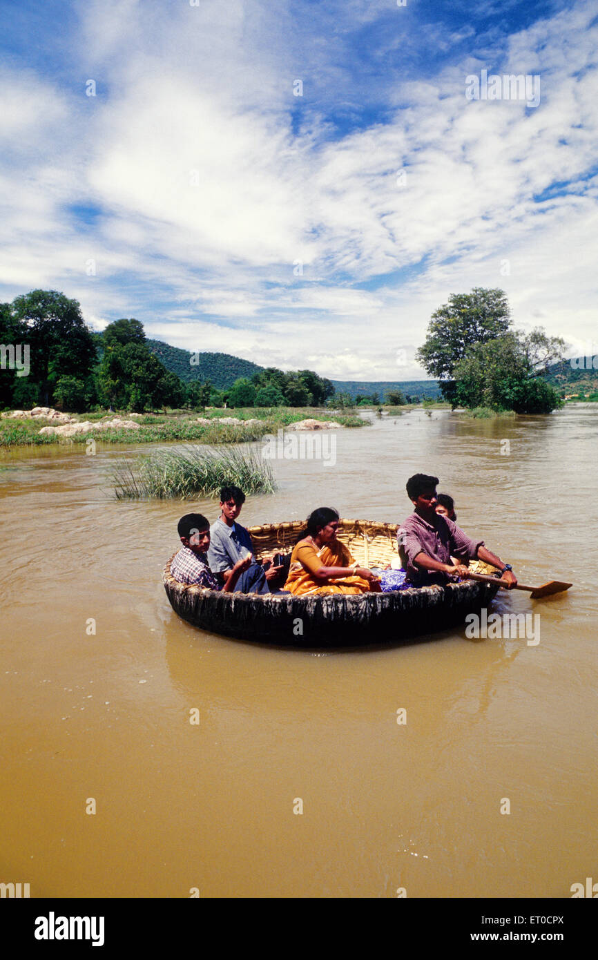 Tourists enjoying coracle ride in cauvery or kaveri river at Hogenakkal ...