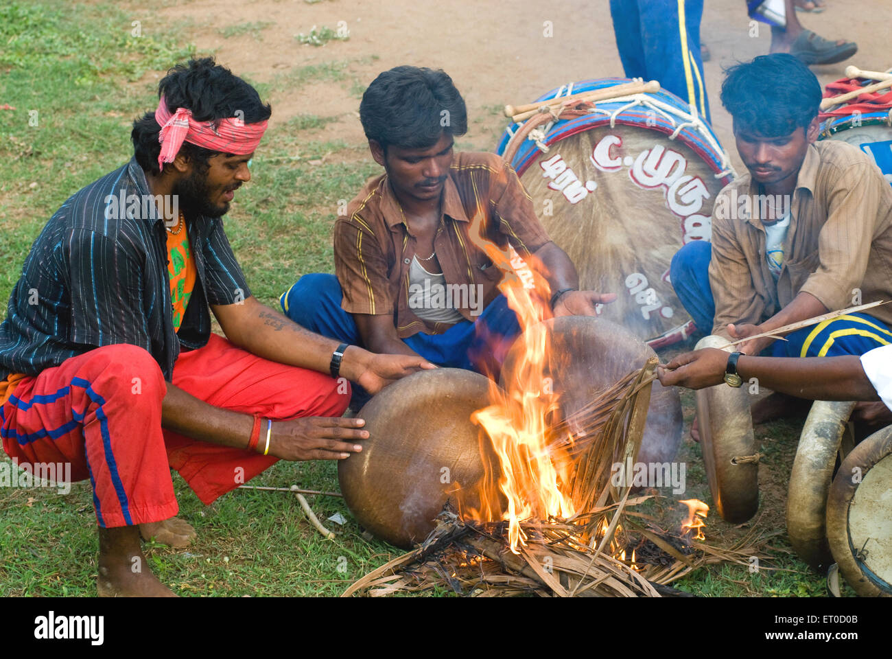 Drummers warming drum ; Tamil Nadu ; India August 2009 NO MR Stock ...