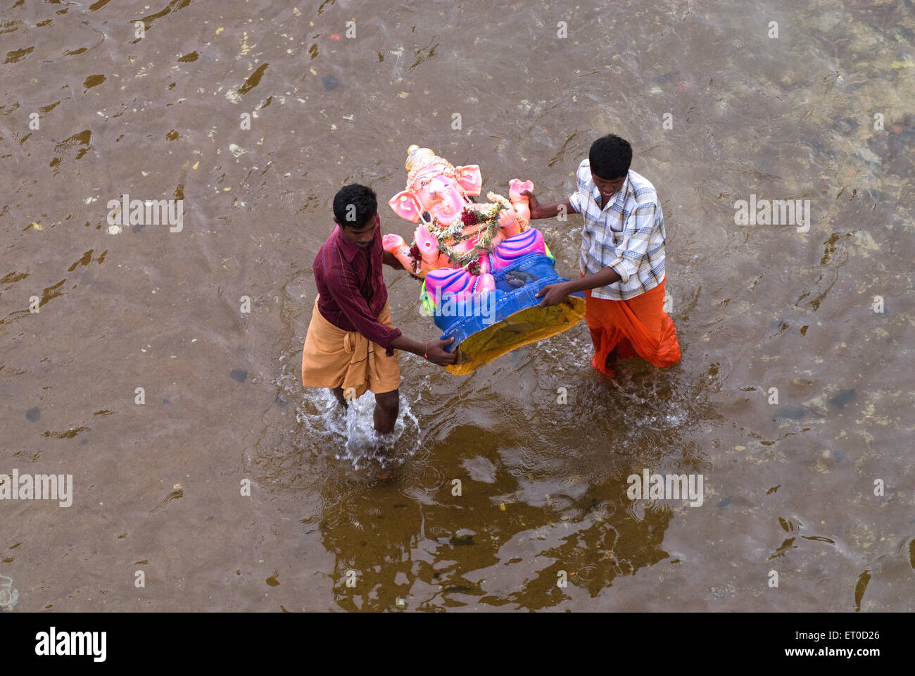 People carrying idol of lord ganesh for immersion in river bhavani on ...