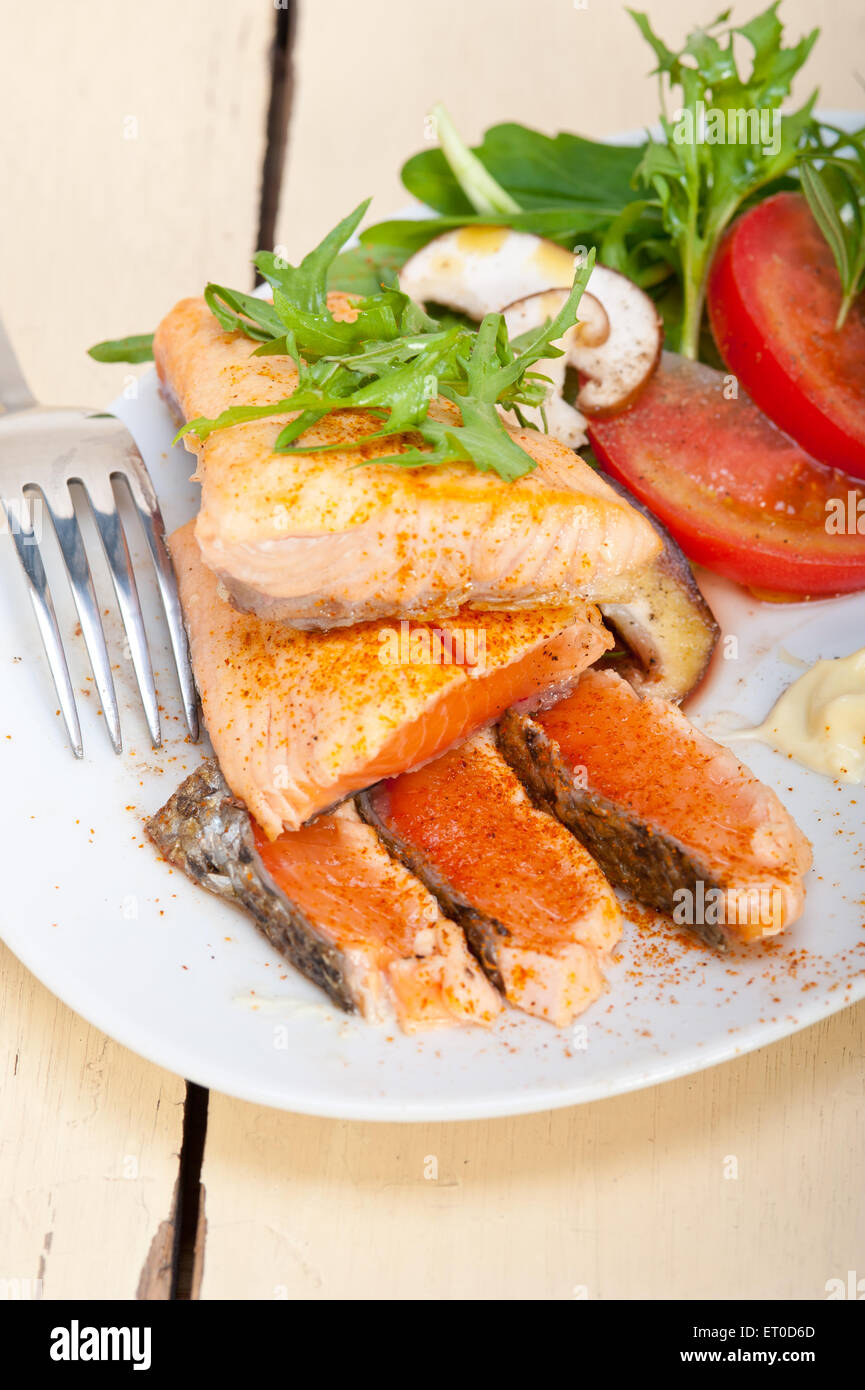 grilled fresh samon filet with vegetables salad tomato arugula ...