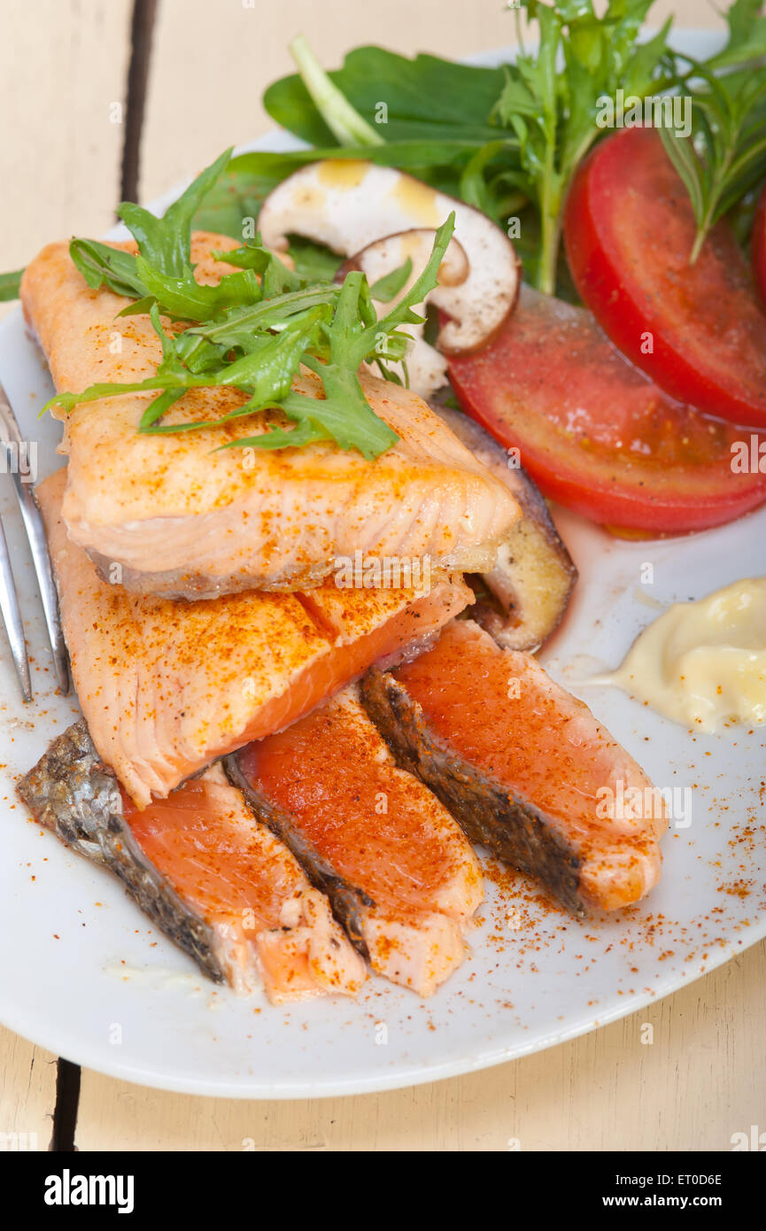 grilled fresh samon filet with vegetables salad tomato arugula ...