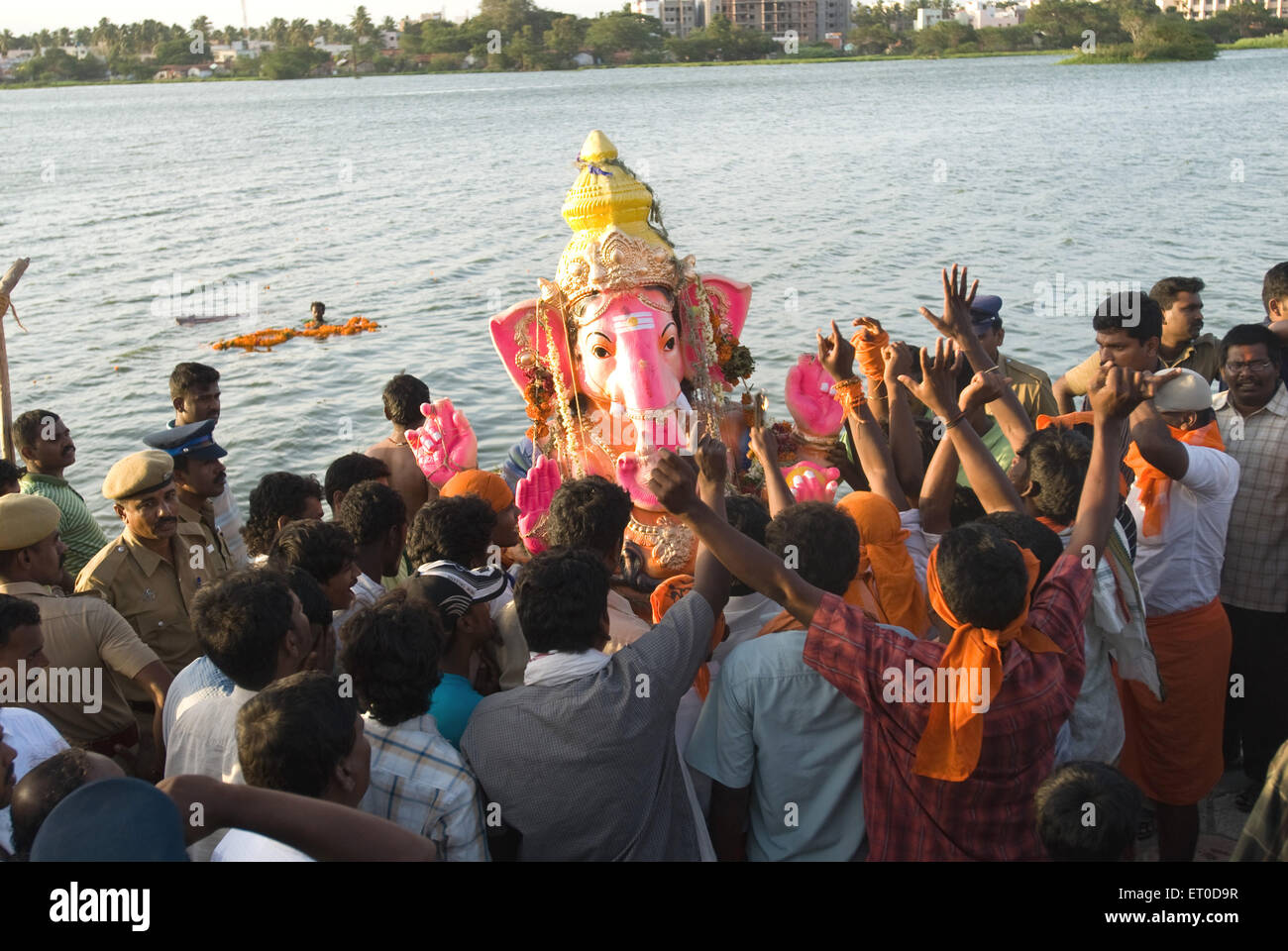 People carrying idol of lord ganesh for immersion at pond on ganpati ...