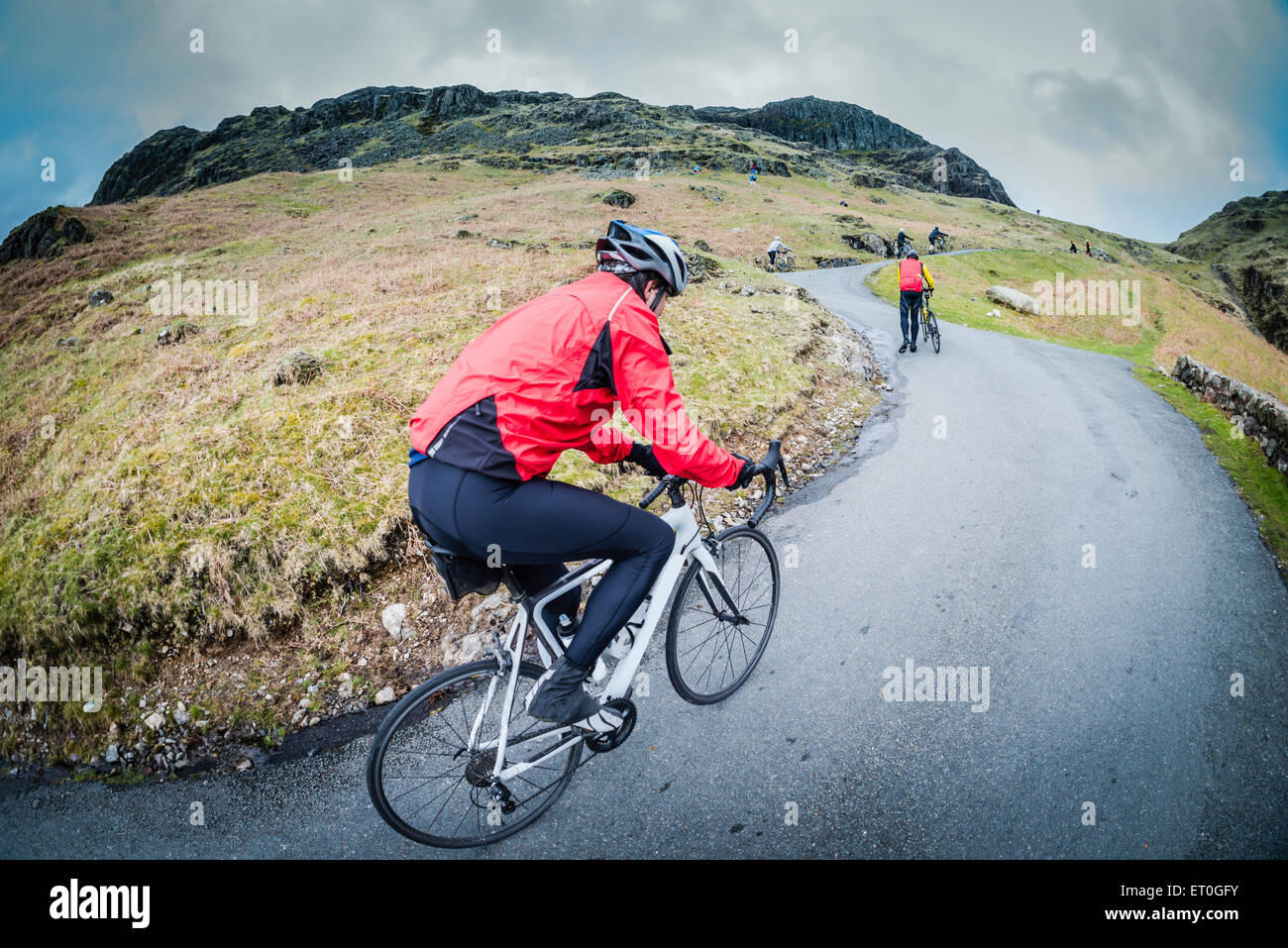 Cyclist climbing the Hardknott Pass in Cumbria Stock Photo - Alamy