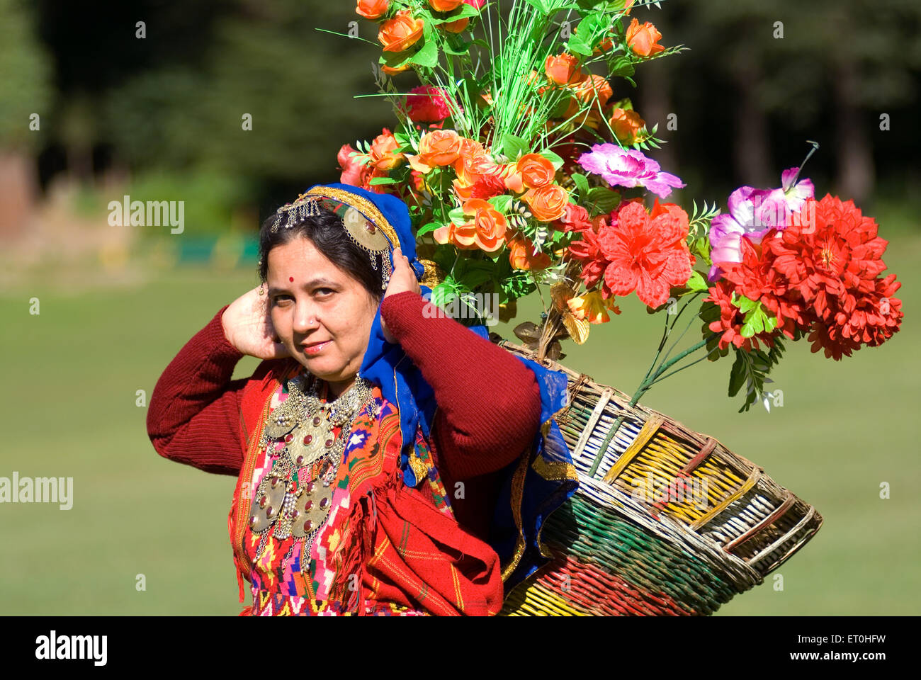 Women in traditional dress holding rabbit at khajjiar ; Himachal ...