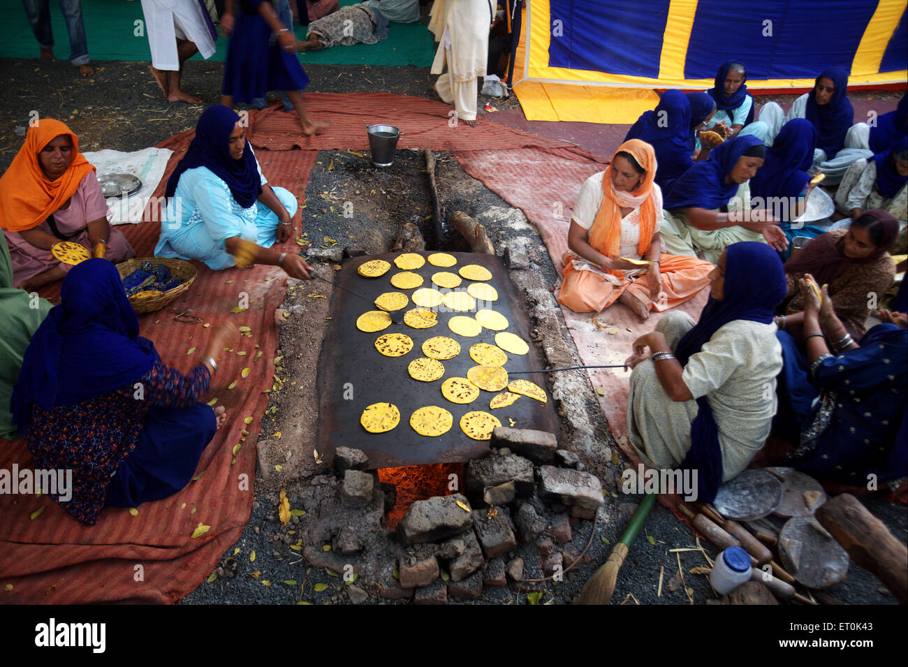 Sikh devotees making makai di rotis corn flour bread kitchen ;guru ...