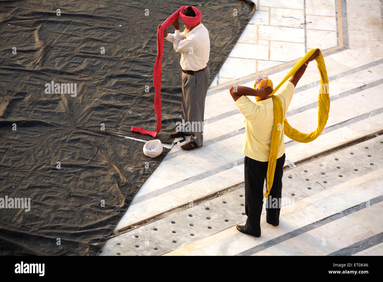 Sikh devotees tying their Pag or head gear in the compound of Sachkhand ...