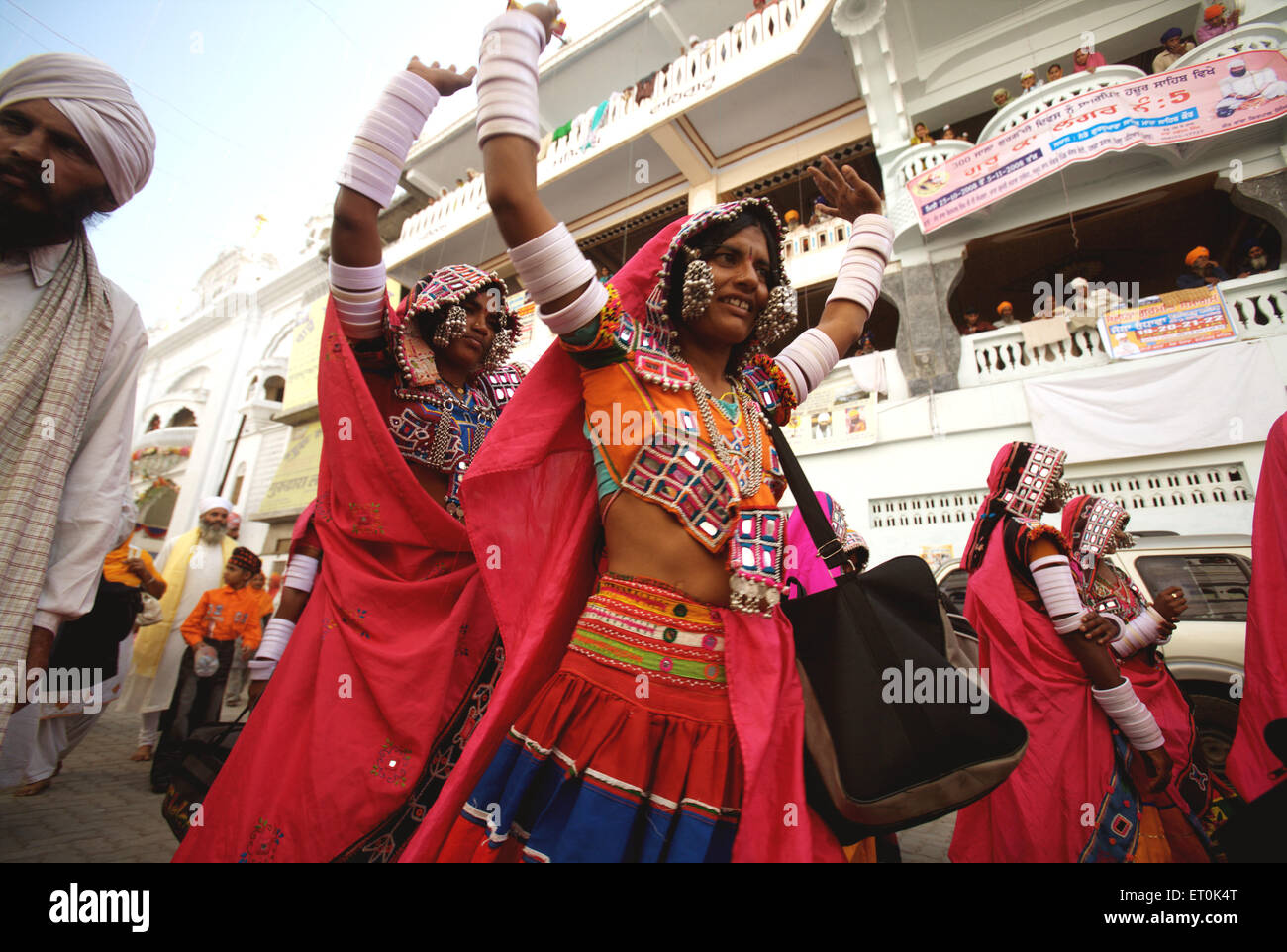 Group of nomad women dressed in colourful attire dancing outside ...