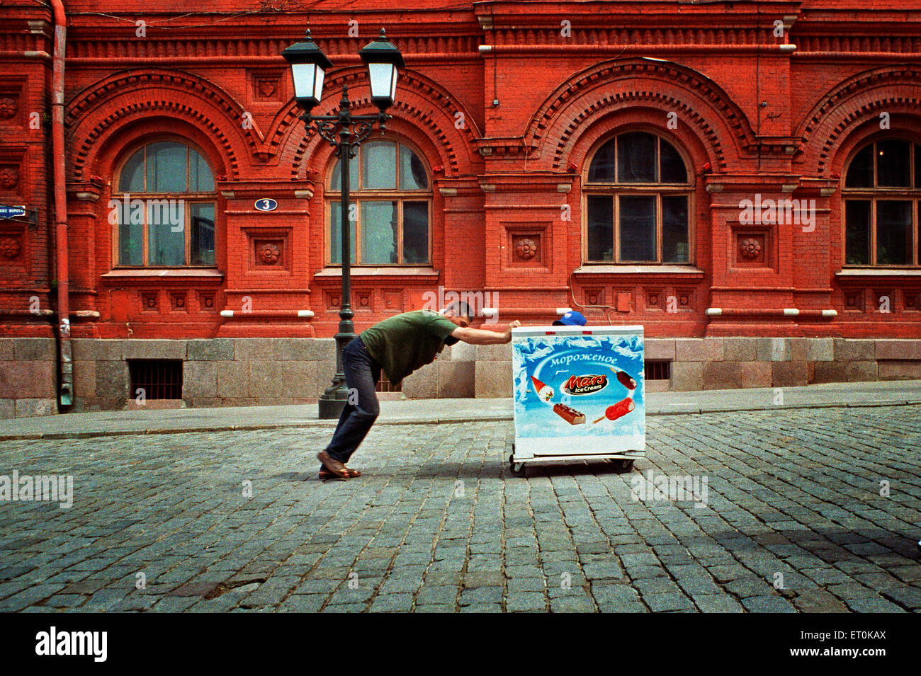 Man pushing a fridge in the red square, Moscow. Russia Stock Photo - Alamy