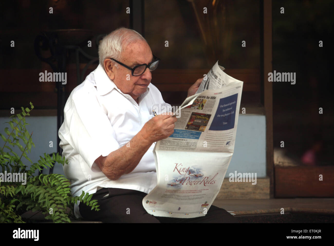 Senior Tata Officer Rusy Modi with newspaper sitting at stairs of his ...