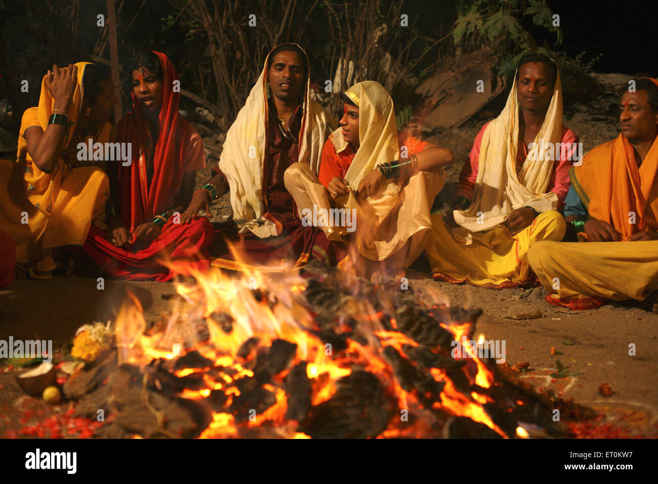 Eunuchs sitting around burning pyre during wedding of eunuchs on ...