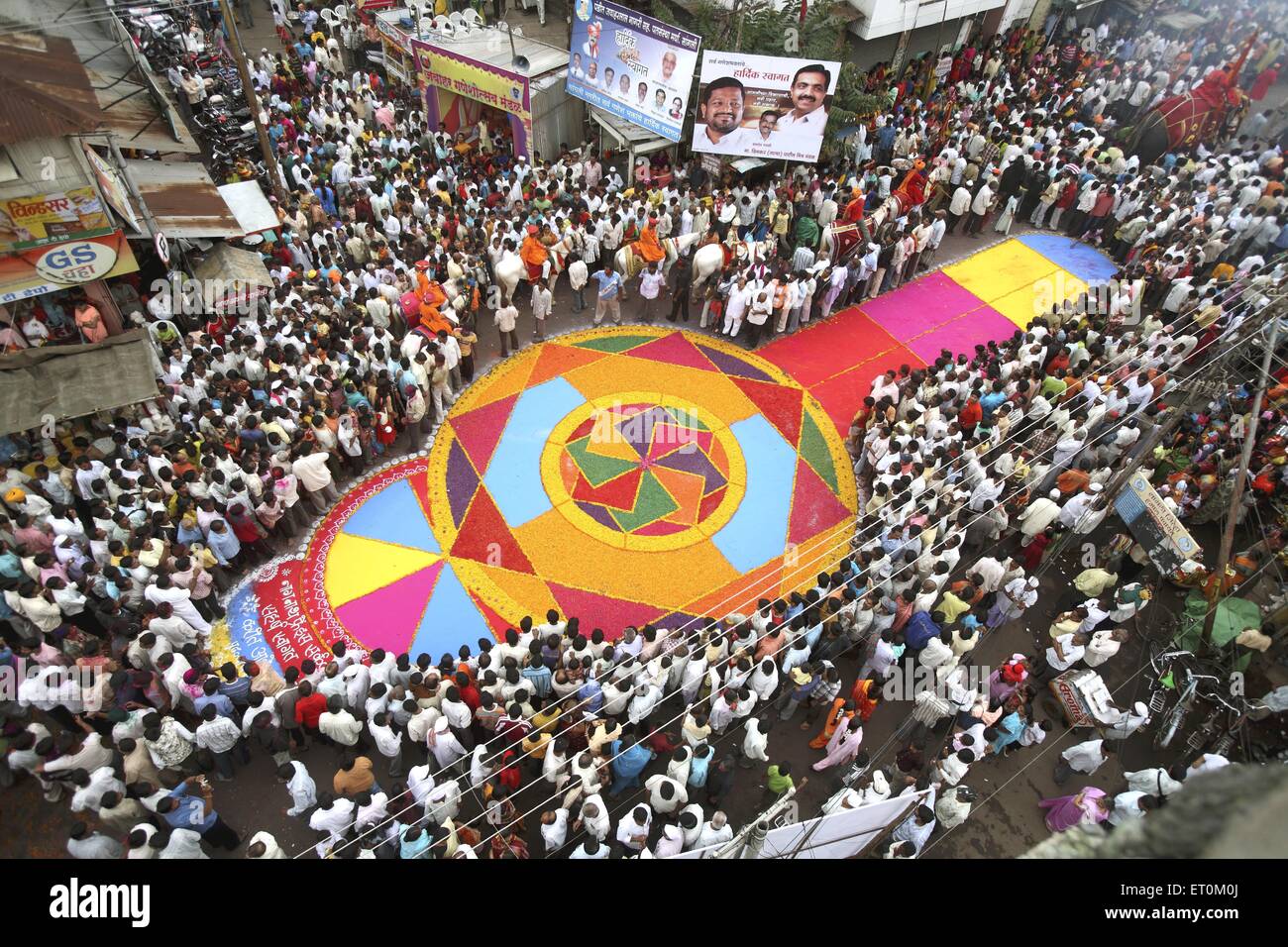 Grand colourful flower Rangoli made on road for immersion celebration ...