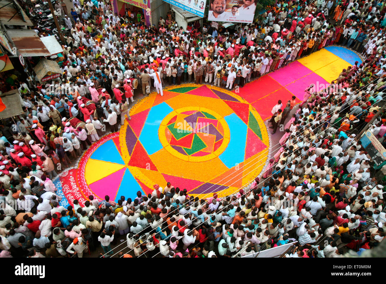 Grand colourful flower Rangoli made on road for immersion celebration ...
