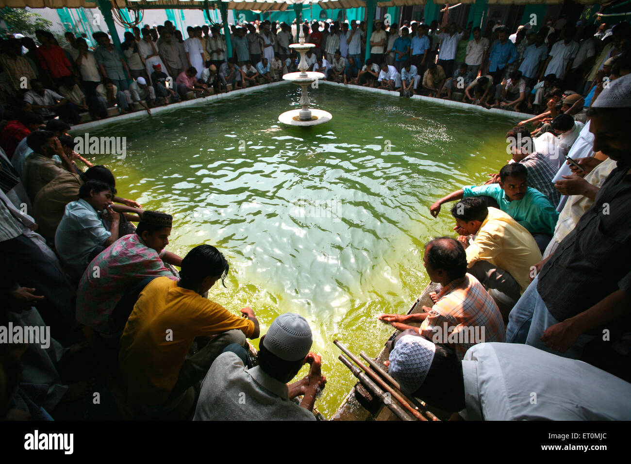 Muslims washing hands before Namaaz at water tank inside compound of ...