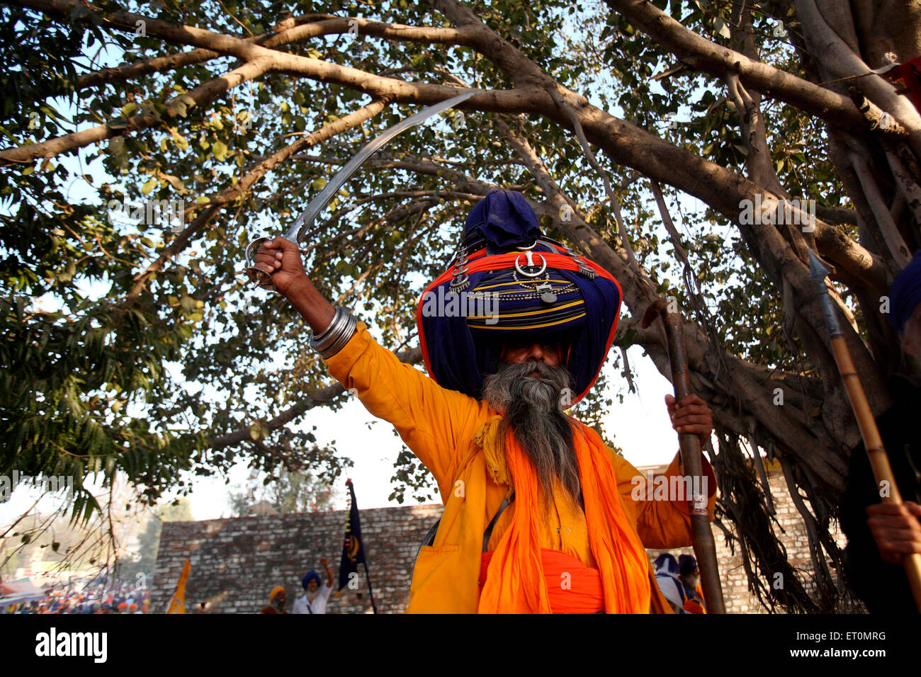 Nihang or Sikh warrior in pagdi or headgear carrying sword and wooden ...