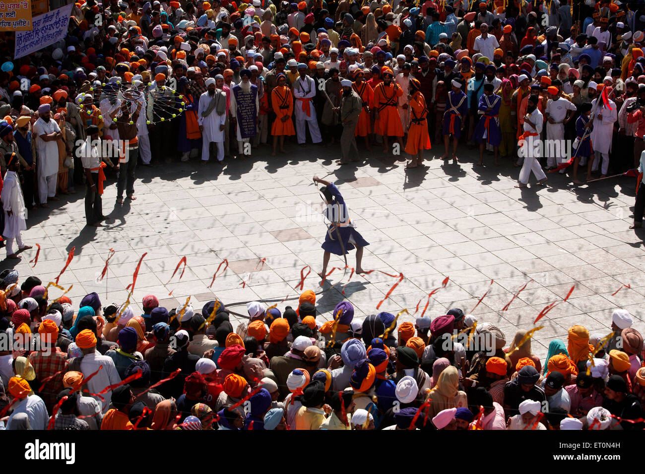 Nihang or Sikh warriors performing stunts with swords during Hola ...