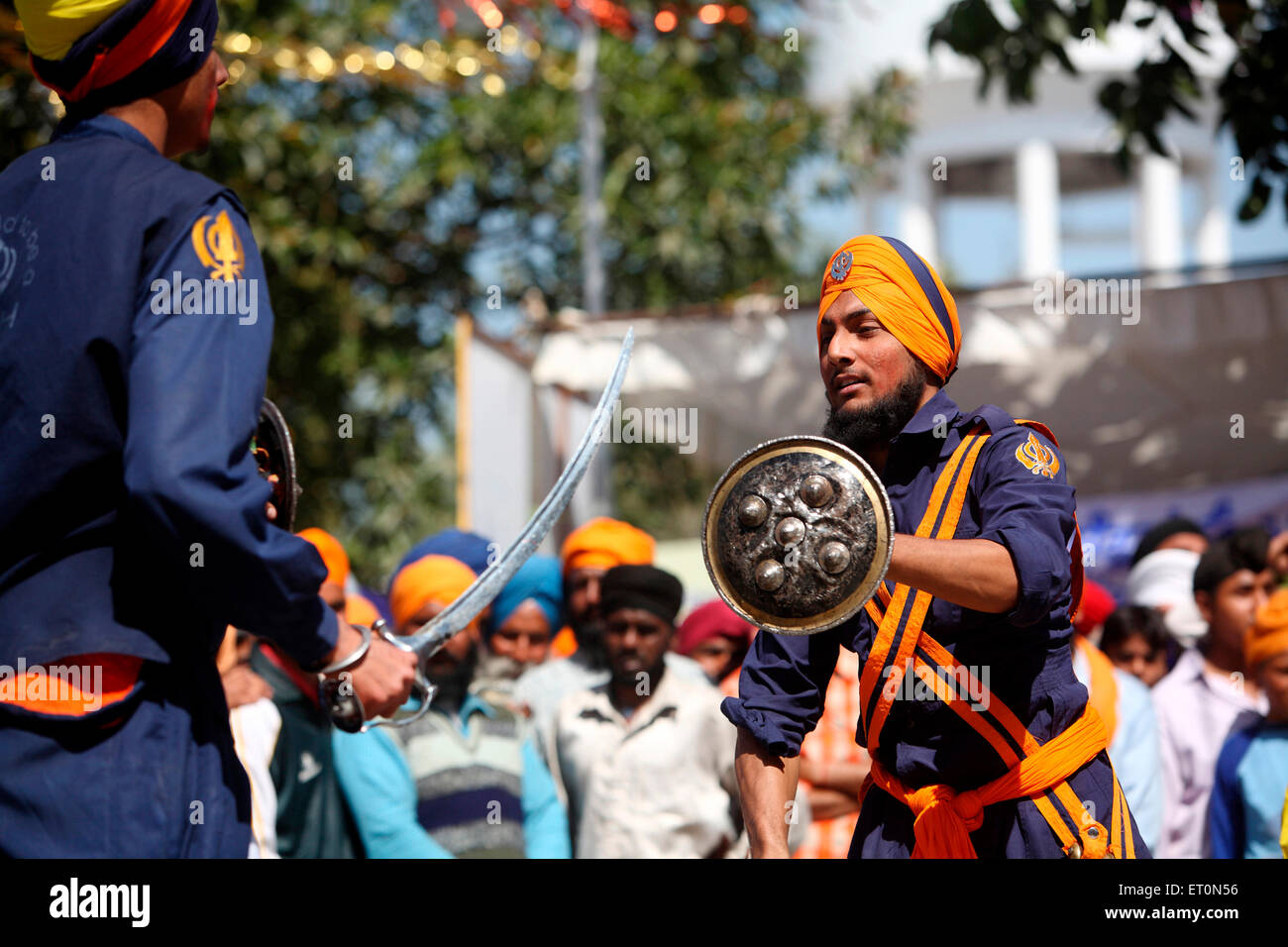 Nihang or Sikh warriors performing stunts with sword and shield in ...