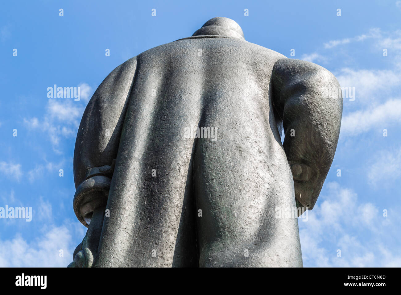 Statue with fat bottom in large trousers on sky background Stock Photo ...