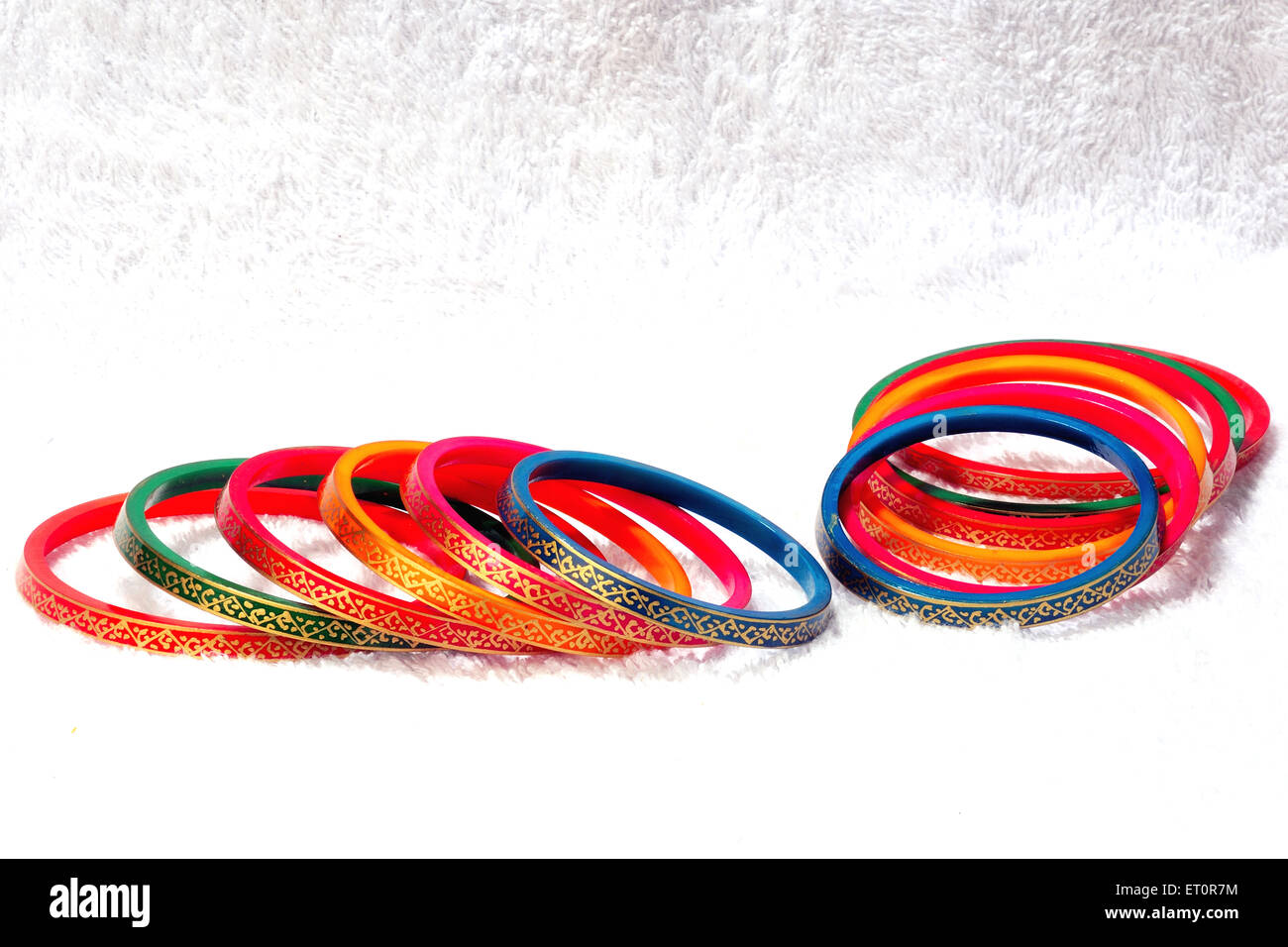Colorful plastic bangles with gold inlay work on white background Stock ...