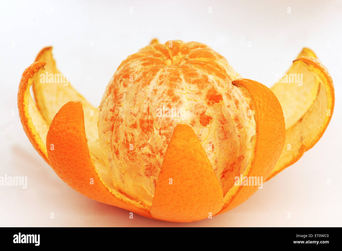 Orange fruit peeled on white background Stock Photo - Alamy