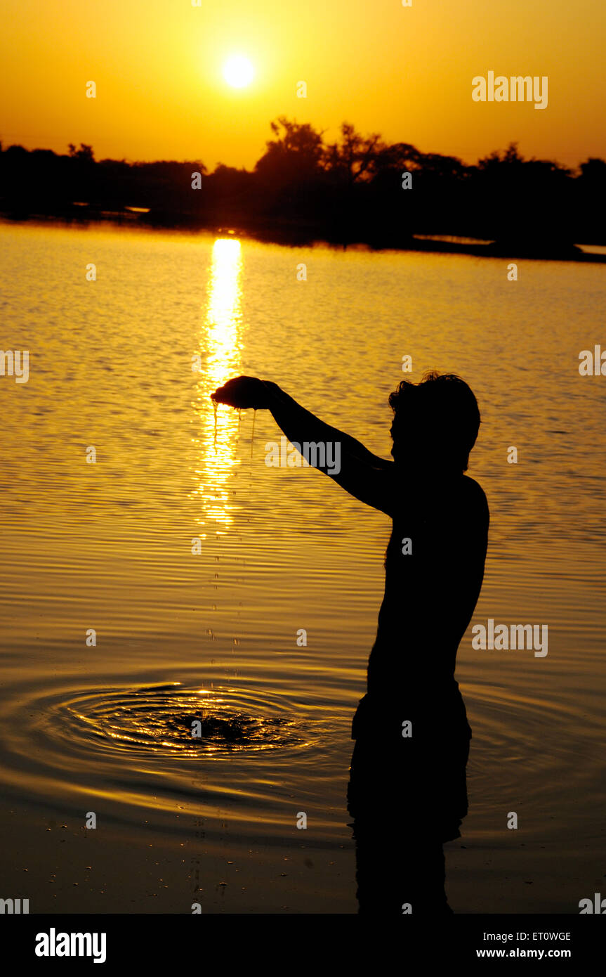 Man worshiping sun ; India Stock Photo - Alamy
