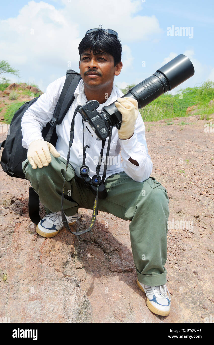 Photographer giving pose while photo shoot ; India Mr#786 Stock Photo ...