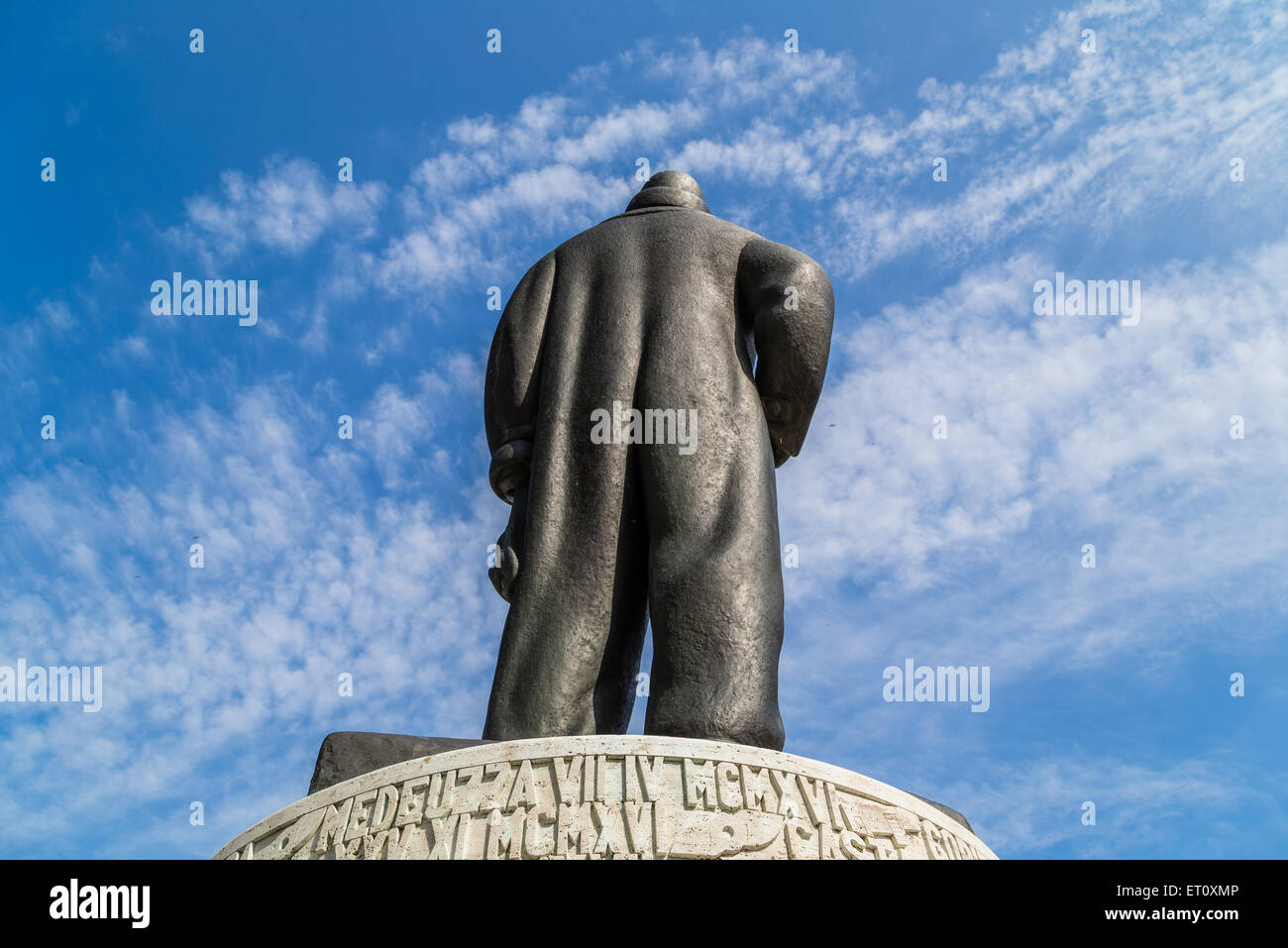 Statue with fat bottom in large trousers on sky background Stock Photo ...